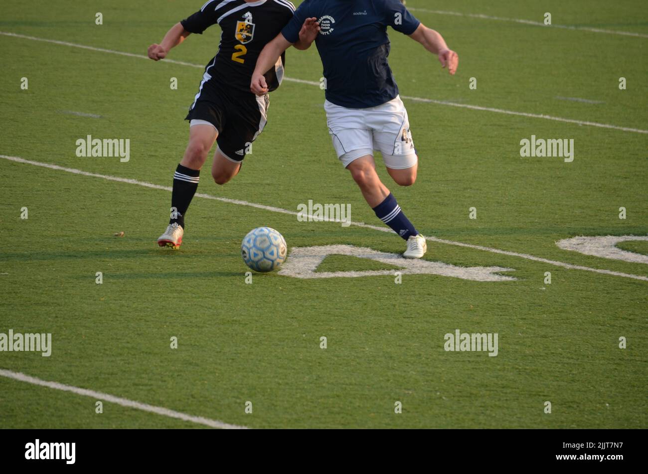 A view of two soccer players competing for a ball Stock Photo - Alamy