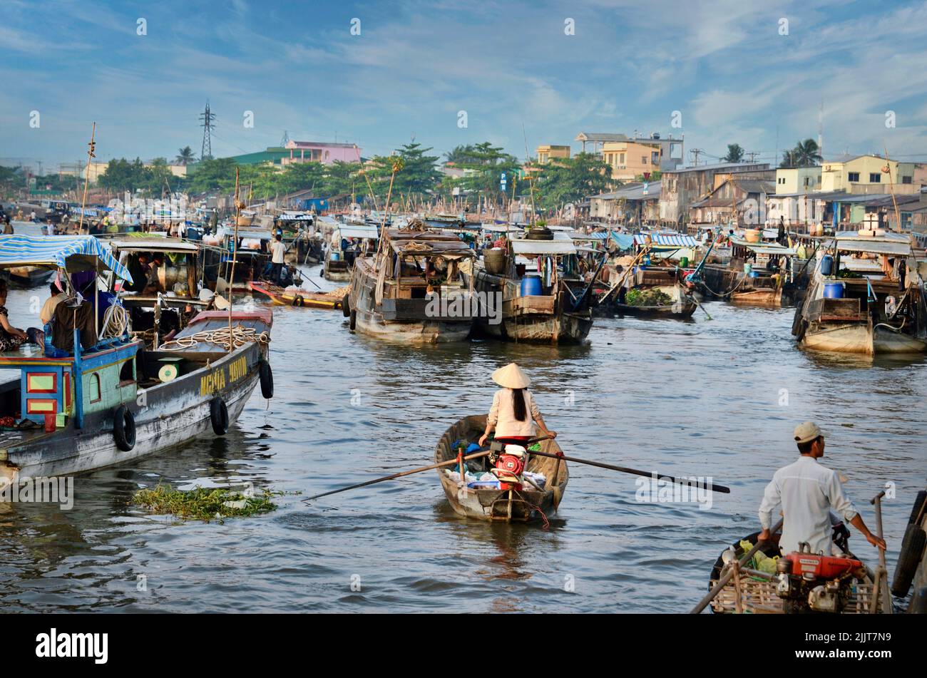A Mekong River with multiple sailing boats showing the lifestyle and hustle of Vietnam Stock ...