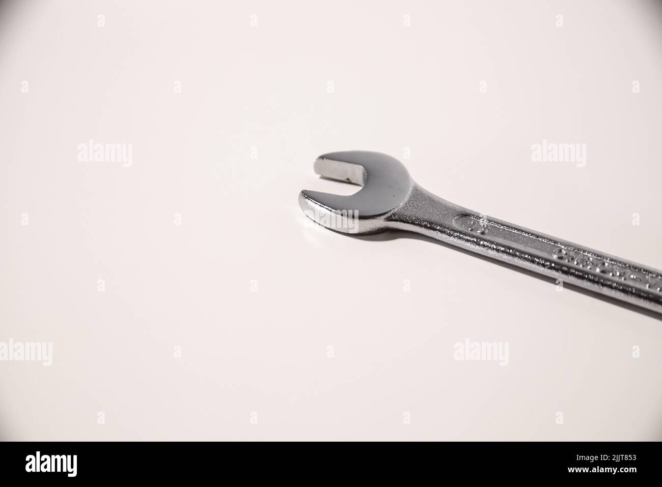 An open wrench isolated on a pink background Stock Photo - Alamy
