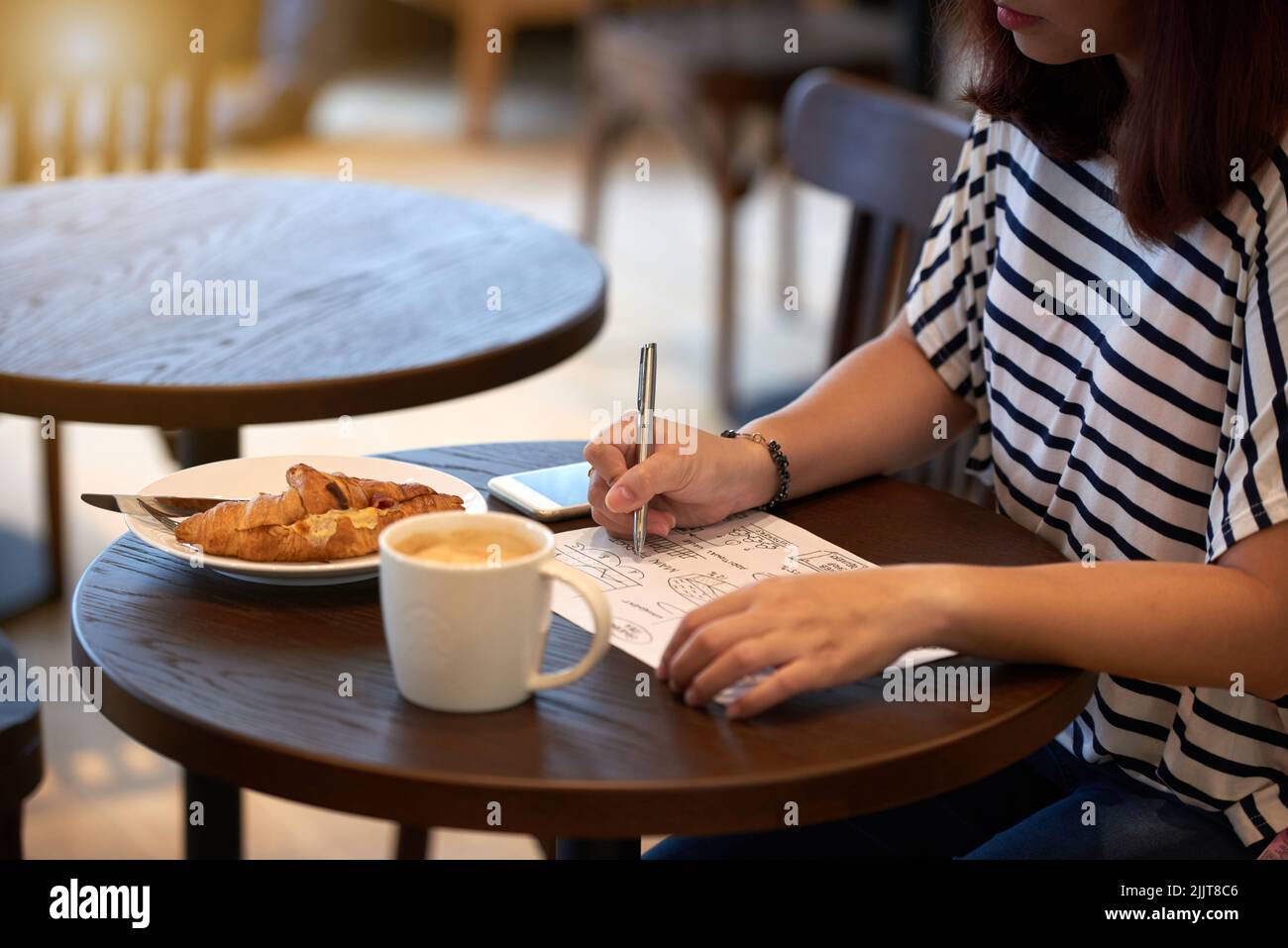 Cropped image of young woman drawing ideas for start-up project when ...
