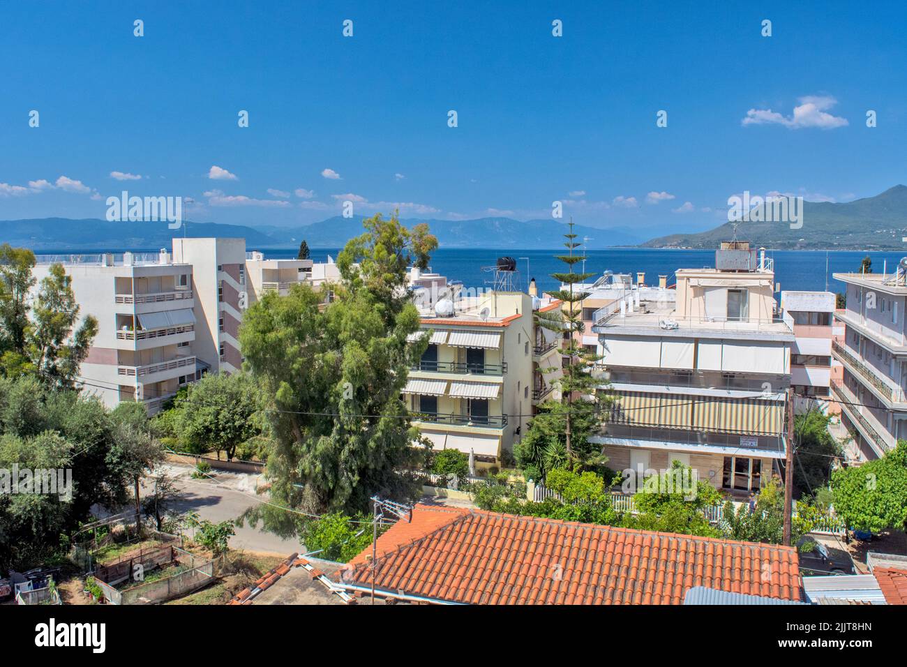 The beautiful modern buildings in a Greek resort on the Aegean coast ...