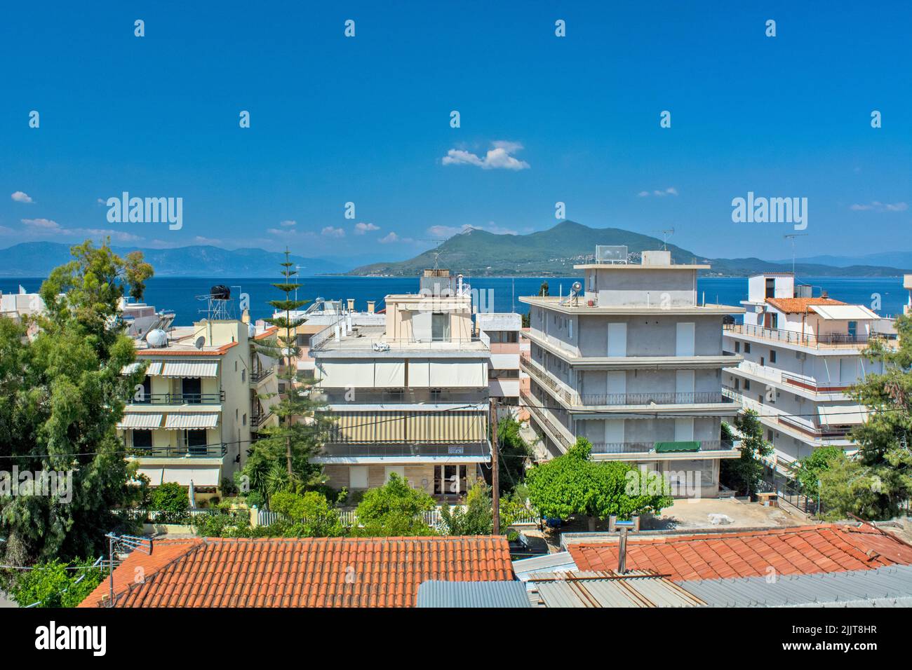The beautiful modern buildings in a Greek resort on the Aegean coast ...