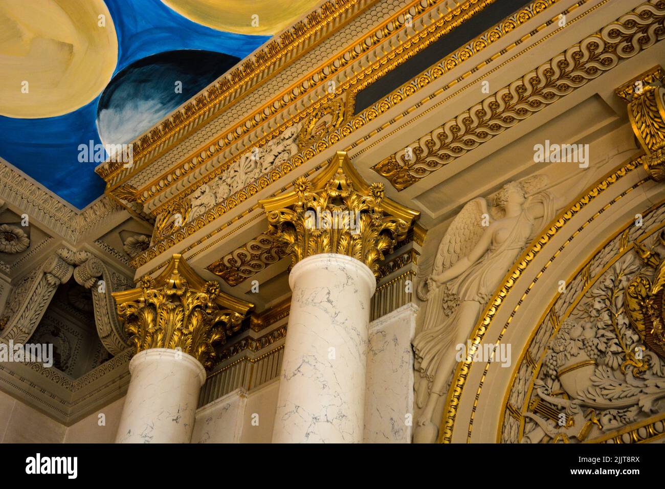 An interior view of a beautiful museum with fancy columns in Paris ...
