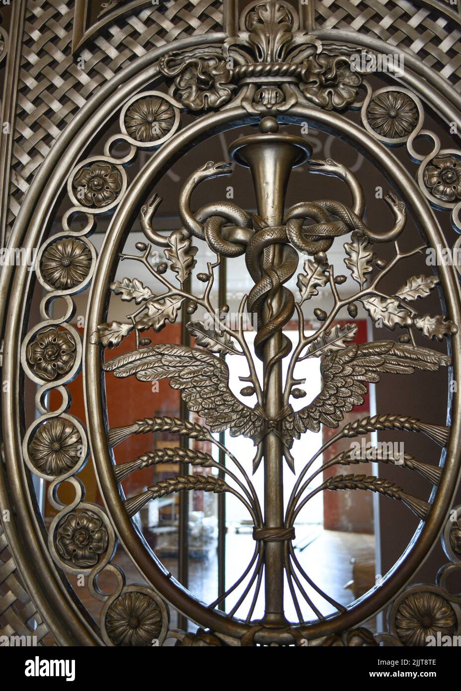 A vertical closeup of metal filigree on door in museum in Paris, France ...