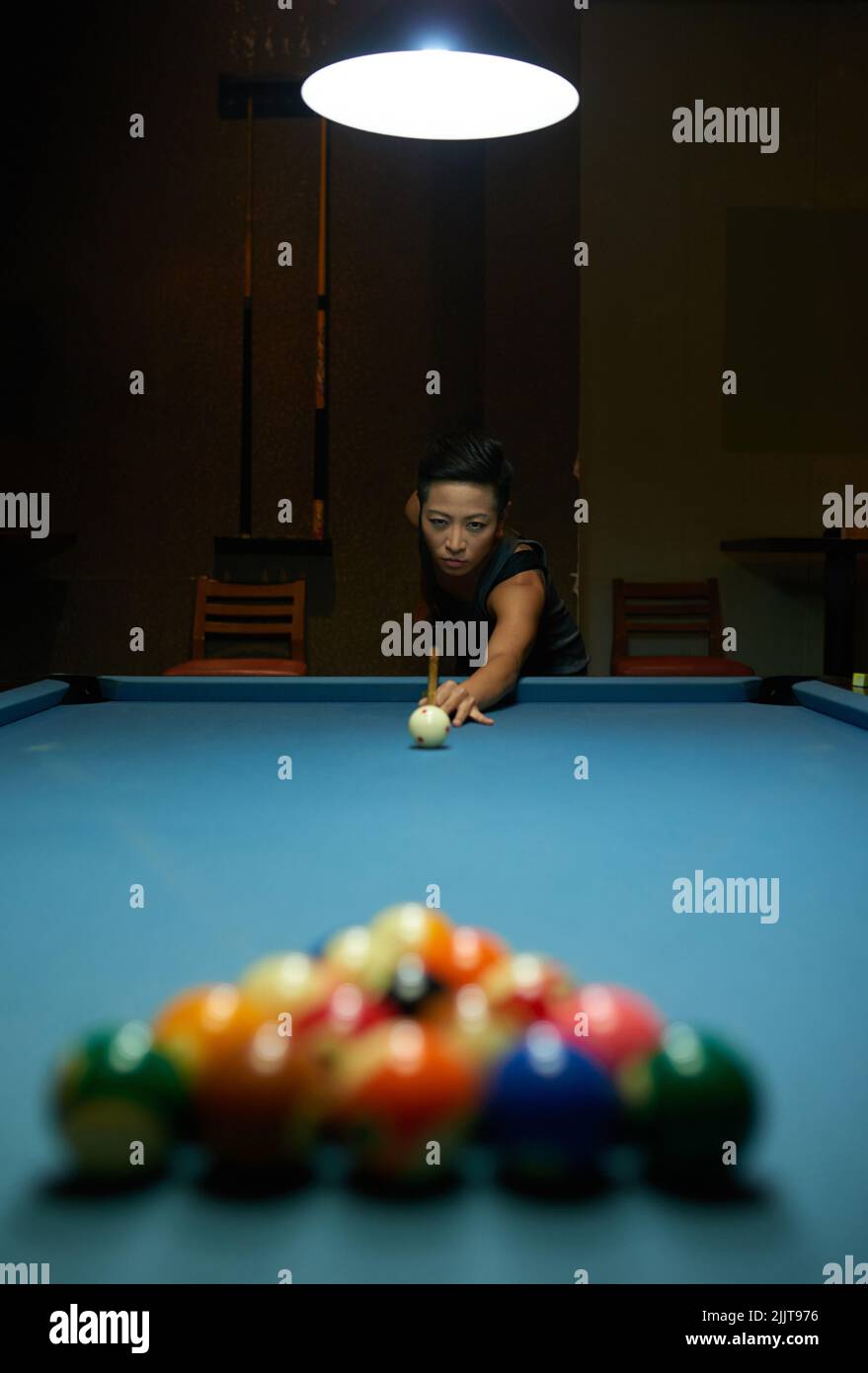 Vietnamese woman playing billiard in dark bar Stock Photo - Alamy