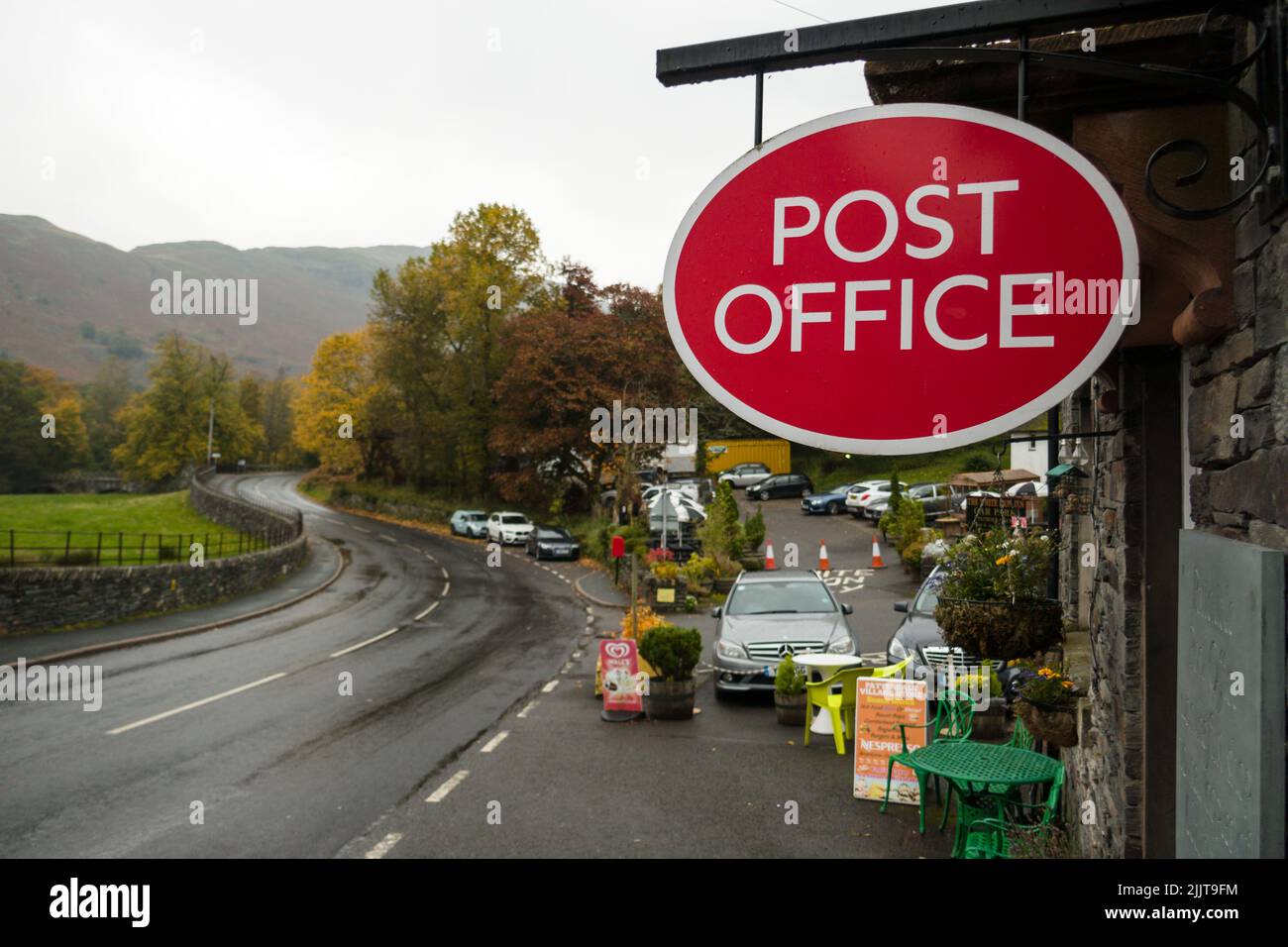 An oval red post office sign and a road Stock Photo - Alamy