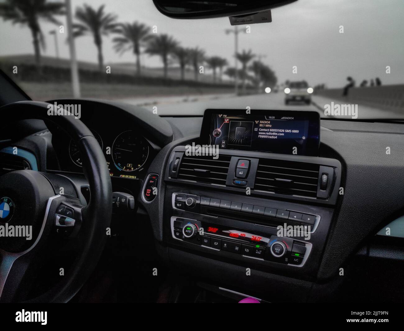 A beautiful shot of the interiors of a BMW M4 with the view of a street ...