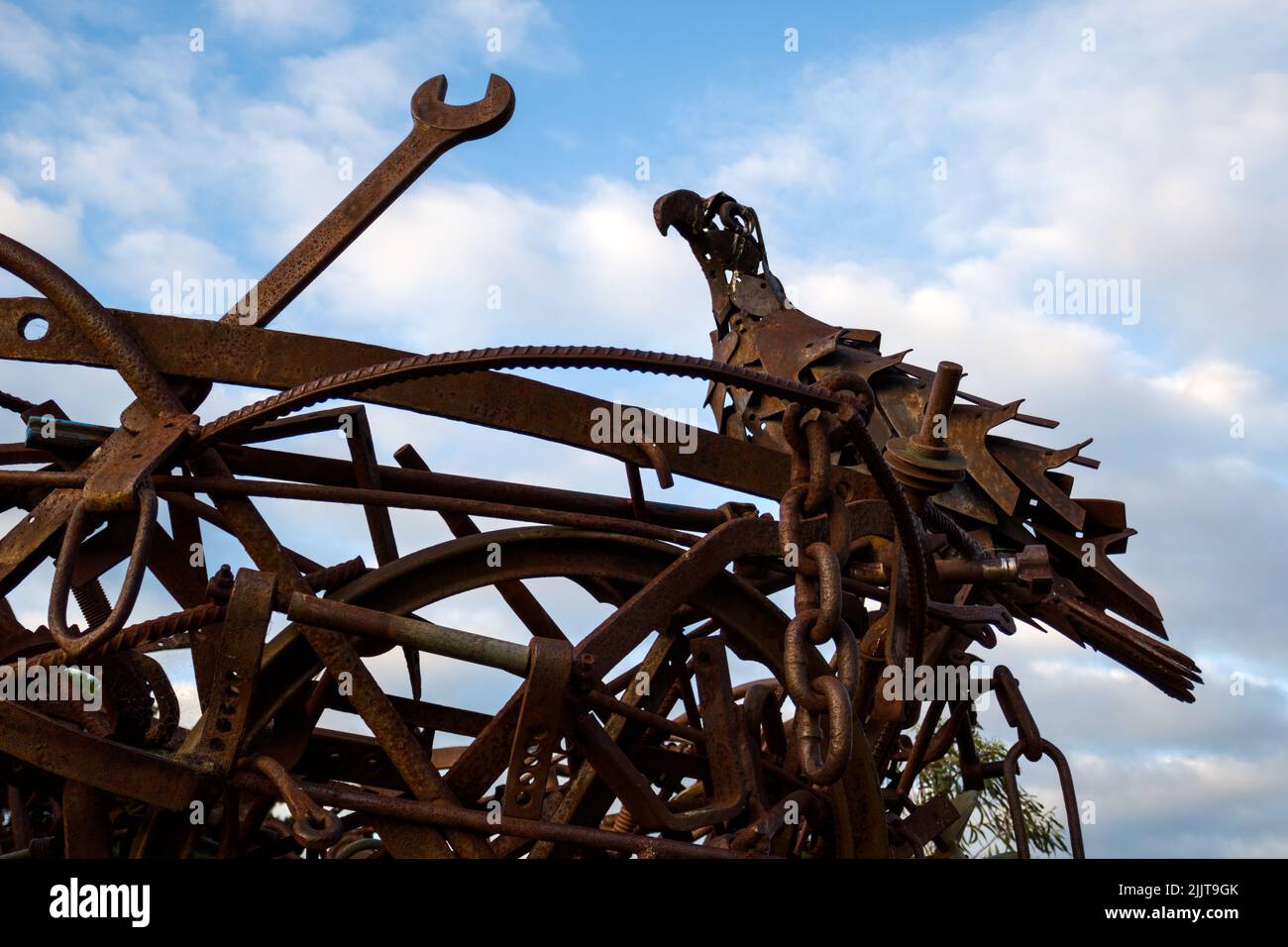 The detail of a rusty steel modern sculpture showing a spanner and a ...