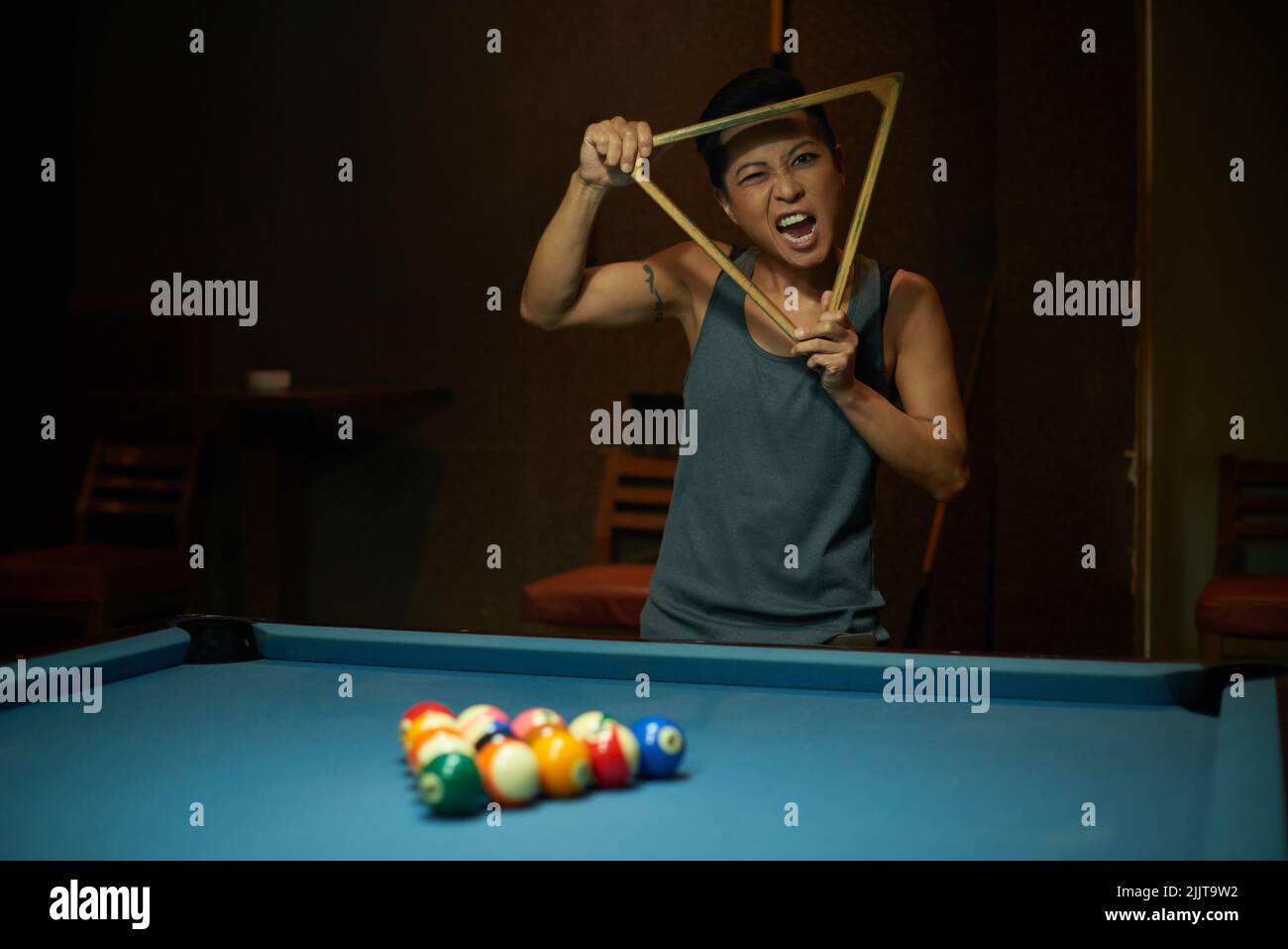 Female billiard player with triangle making crazy face Stock Photo - Alamy