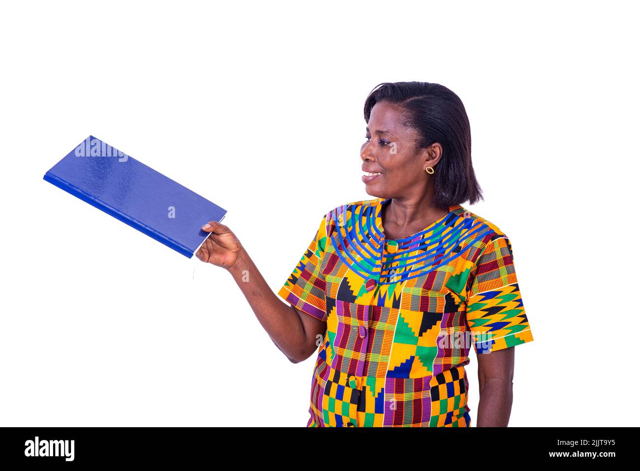 beautiful happy adult woman standing aside and holding a book while ...