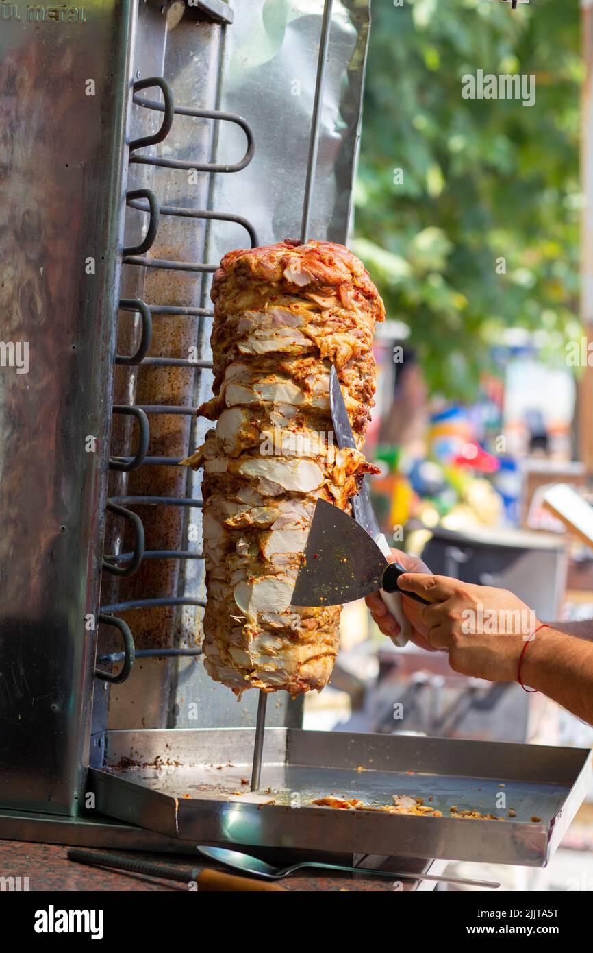 Chef cutting with doner knife Traditional Turkish Doner Kebab meat ...
