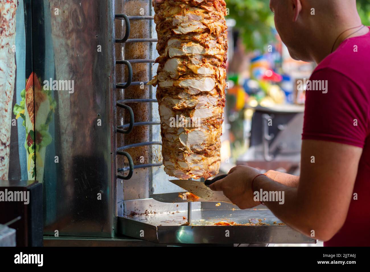 Chef cutting with doner knife Traditional Turkish Doner Kebab meat ...