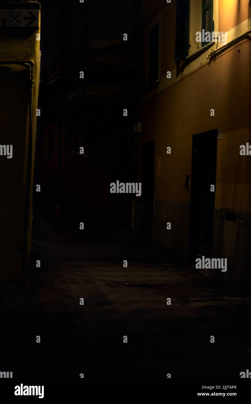 Narrow alley lit by a single street light Stock Photo - Alamy