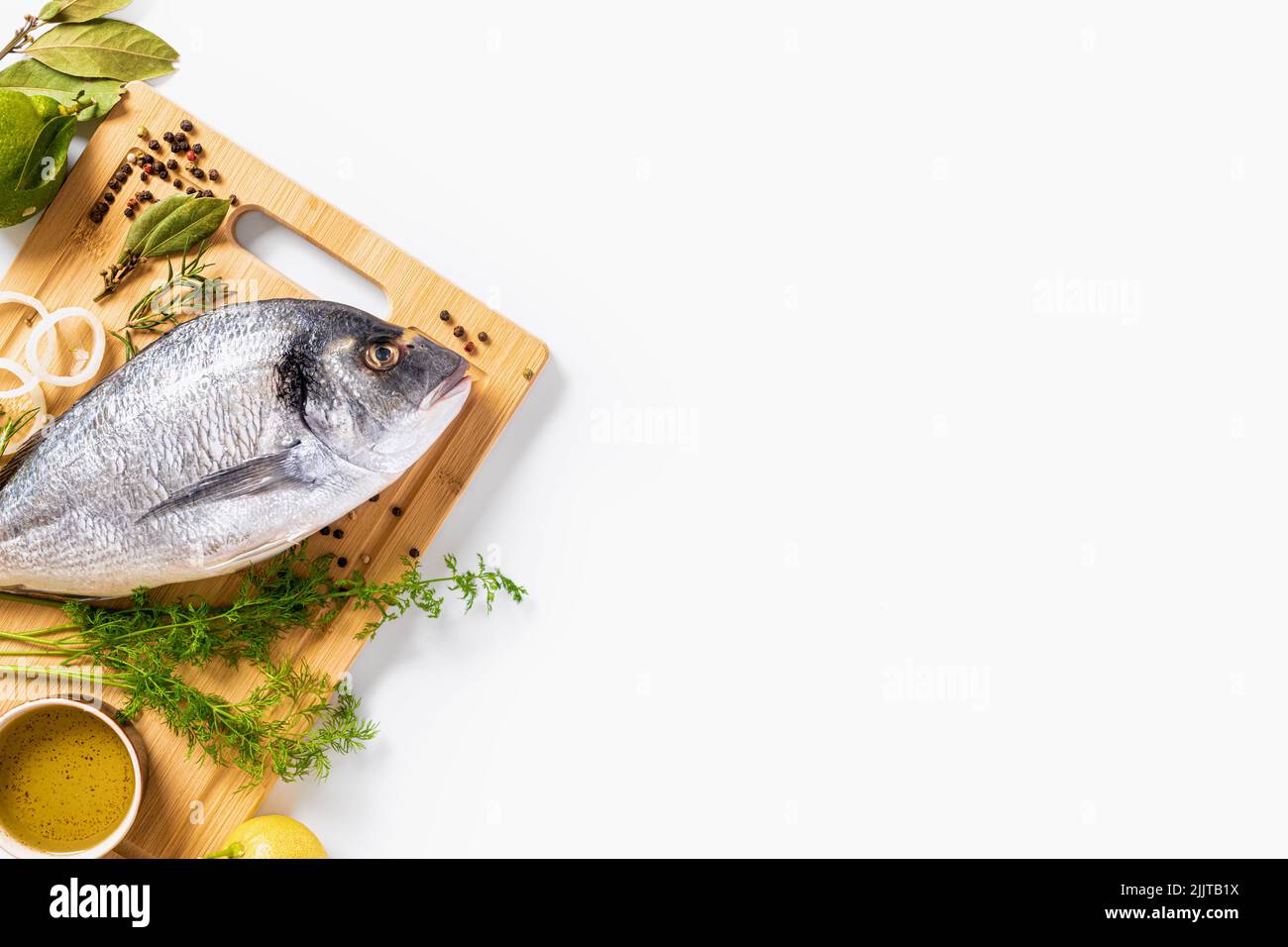 Fresh borabo fish with ingredients for cooking on white background top view Copy space Delicious ...