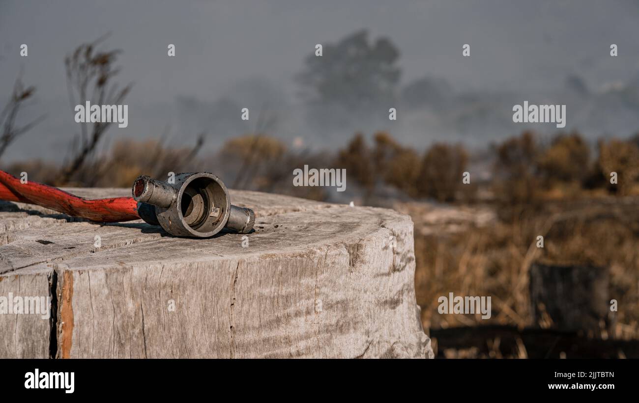 A shallow focus shot of a drought water tap with red hand on a rocky ...