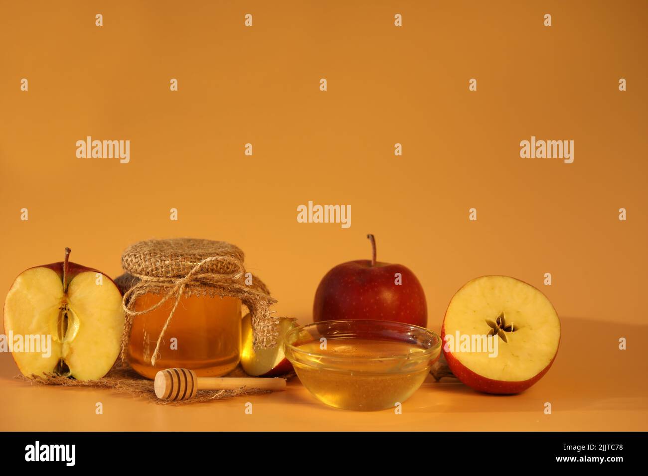 Red fresh apples with honey on yellow background with copy space. Apple ...