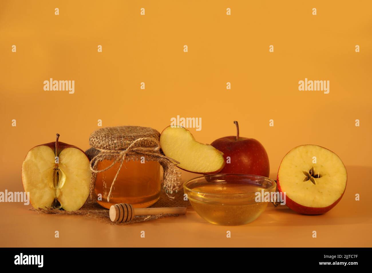 Red fresh apples with honey on yellow background with copy space. Apple ...