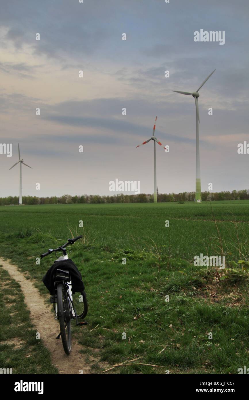 A vertical of a bicycle with clothes with wind turbines in the ...