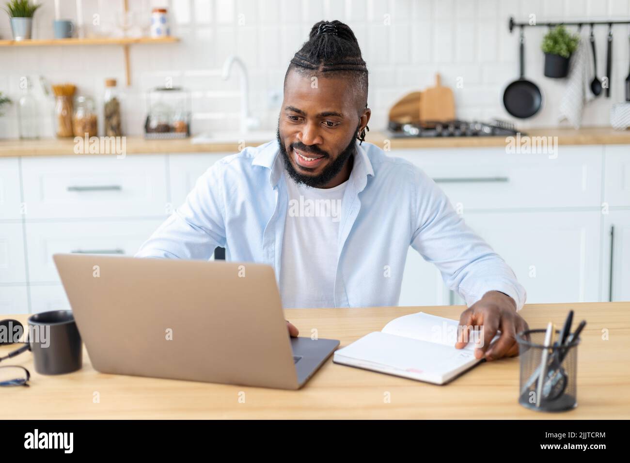 smiling African American confident businessman using laptop computer ...