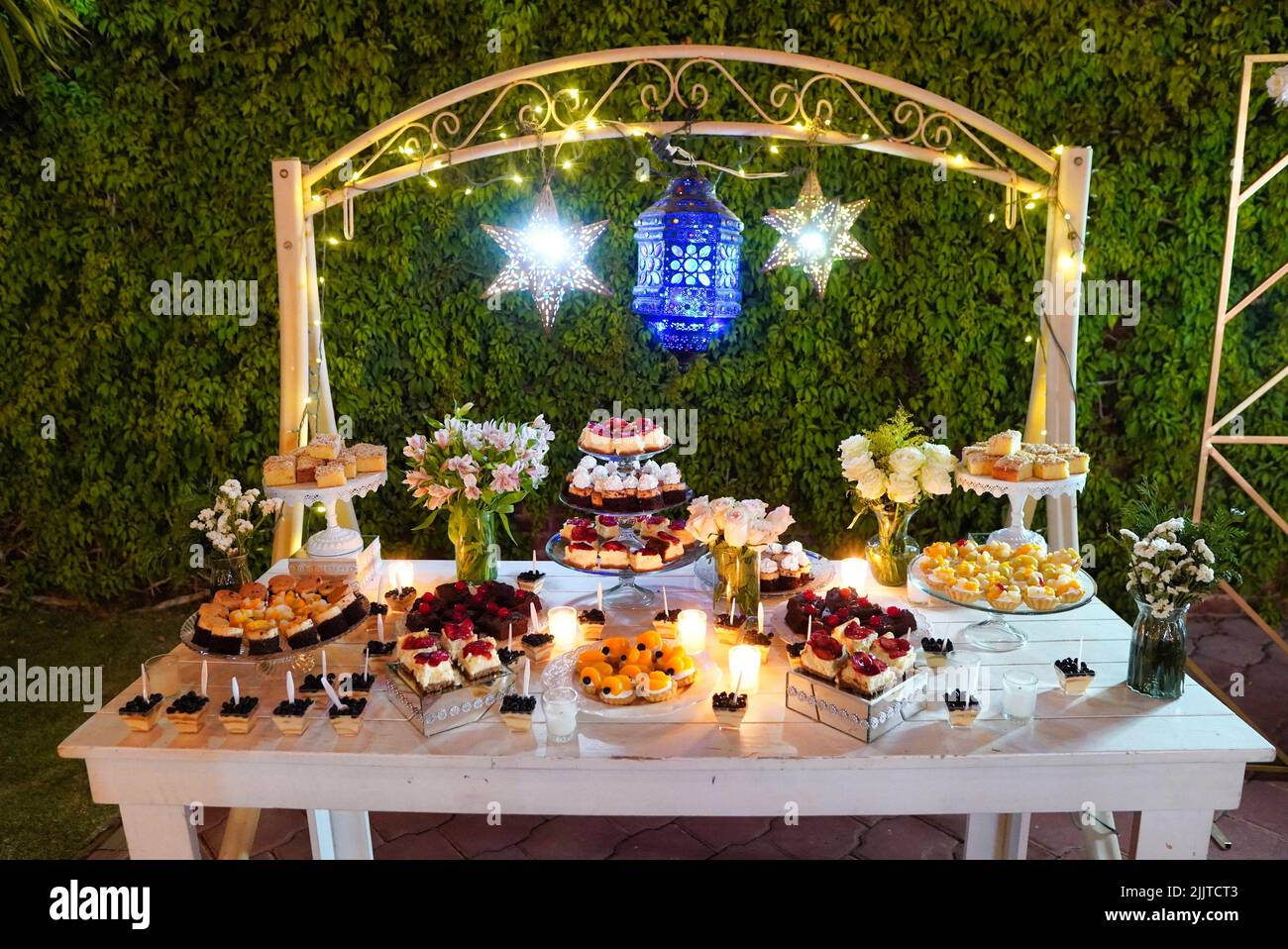 A decorated table with plates of cakes at a wedding reception Stock ...