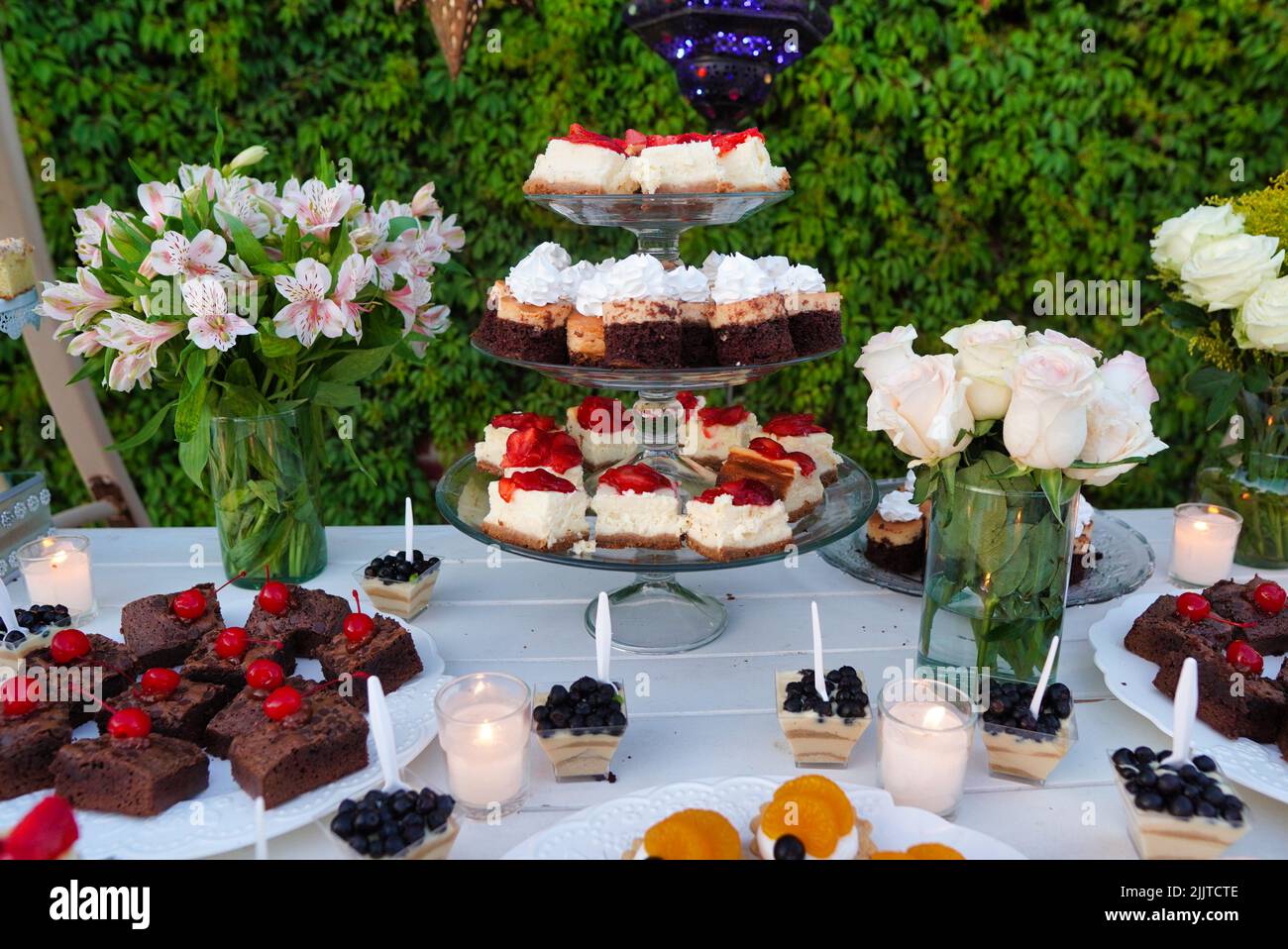A table with plates of cakes at a wedding reception Stock Photo - Alamy