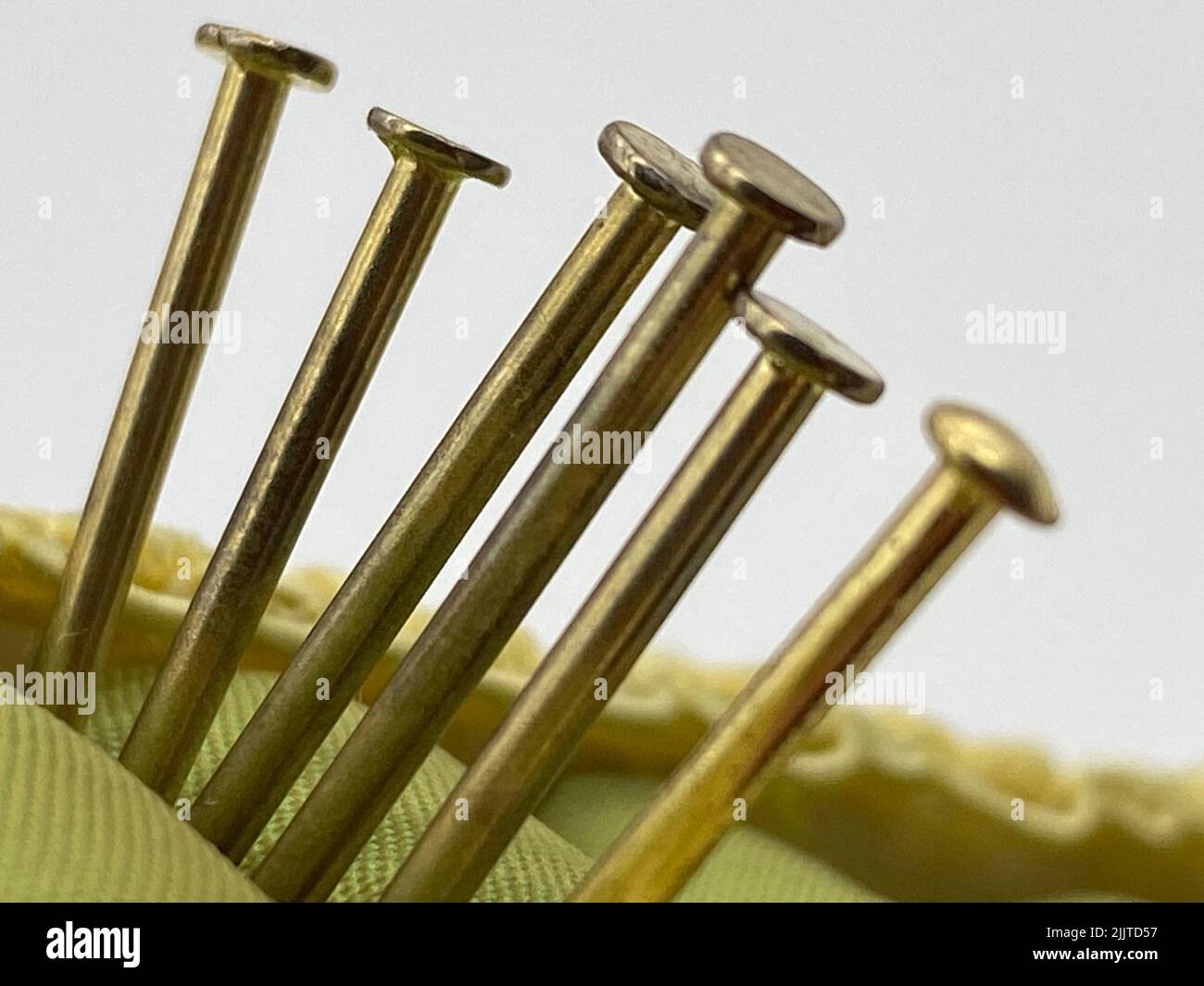 The heap of steel brass nails in a textile box Stock Photo - Alamy