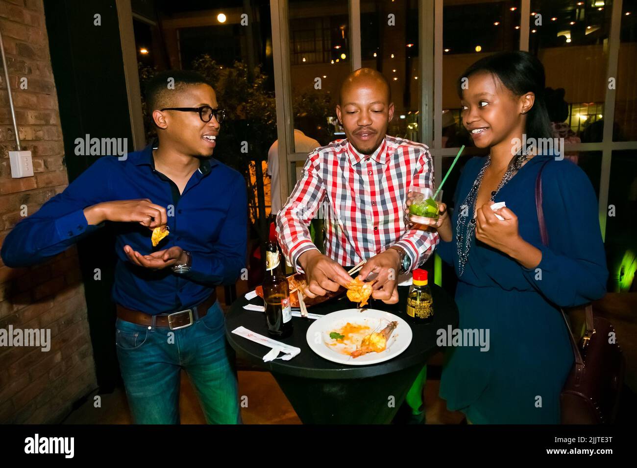 The African guests socialising in sushi restaurant in Johannesburg ...