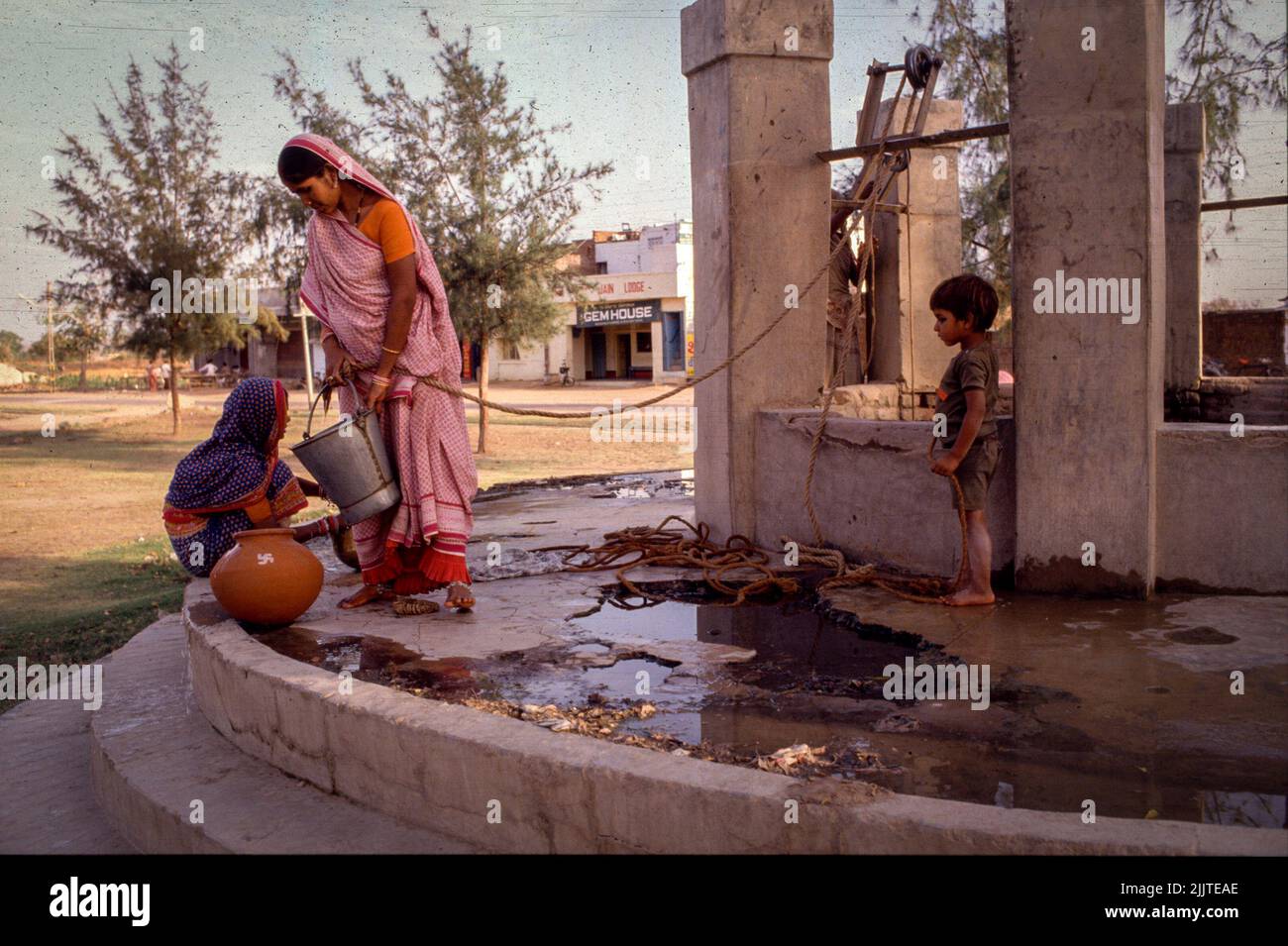 A view of an Indian female with her children collecting water Stock ...