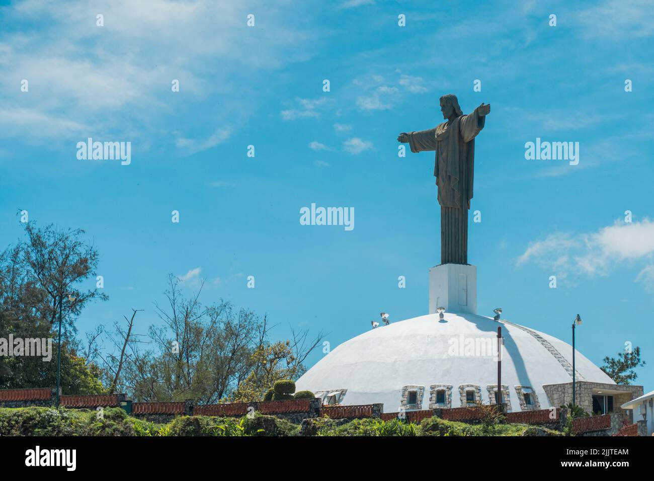 A scenic view of the Jesus statue at the top of Mount Isabel de Torres ...