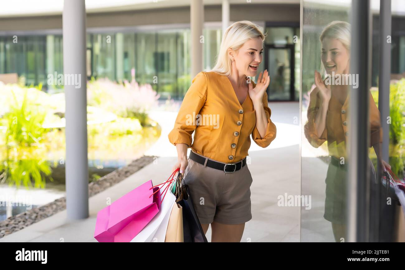 happiness, consumerism, sale and people concept - smiling young woman ...