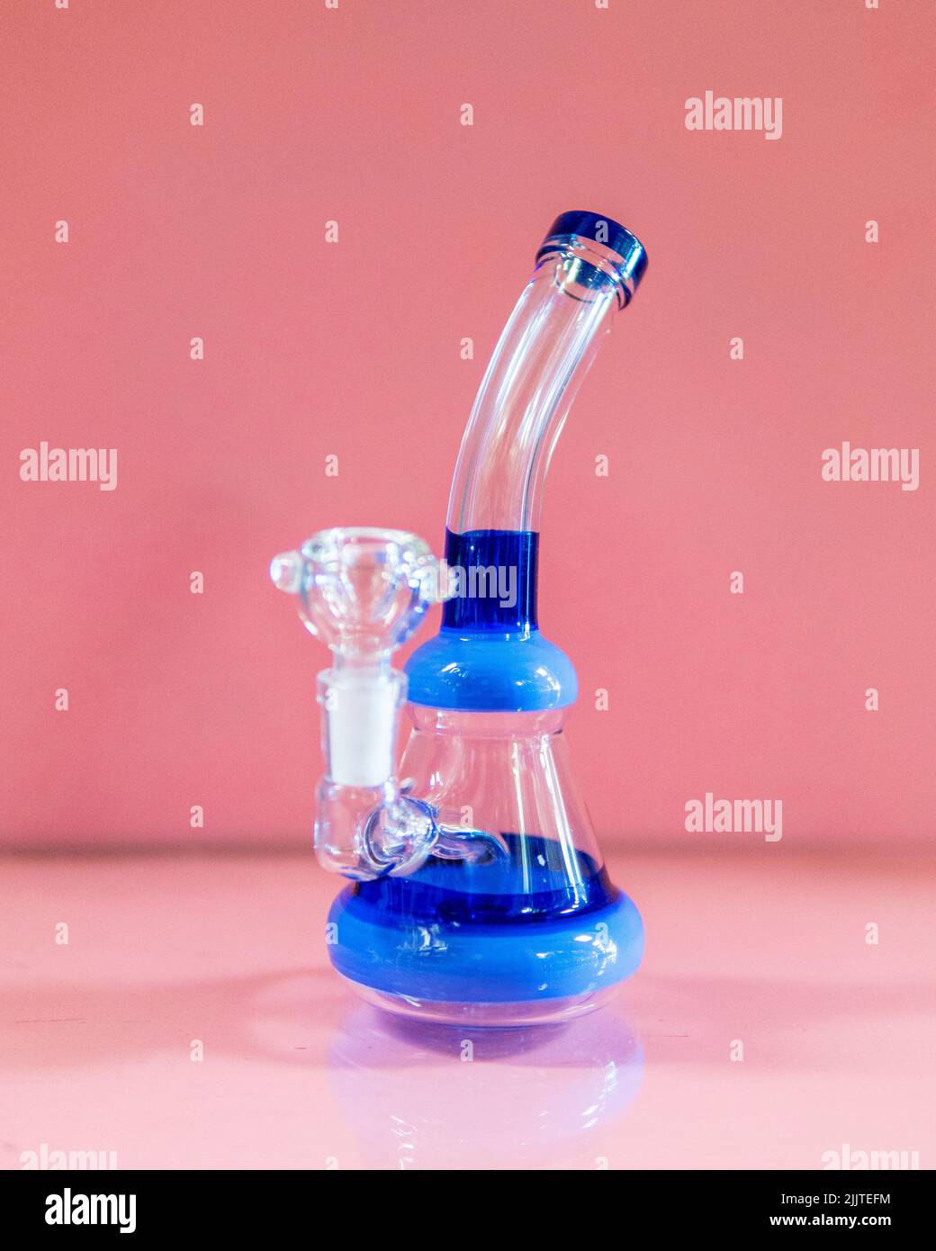 A little bong on a pink background Stock Photo - Alamy