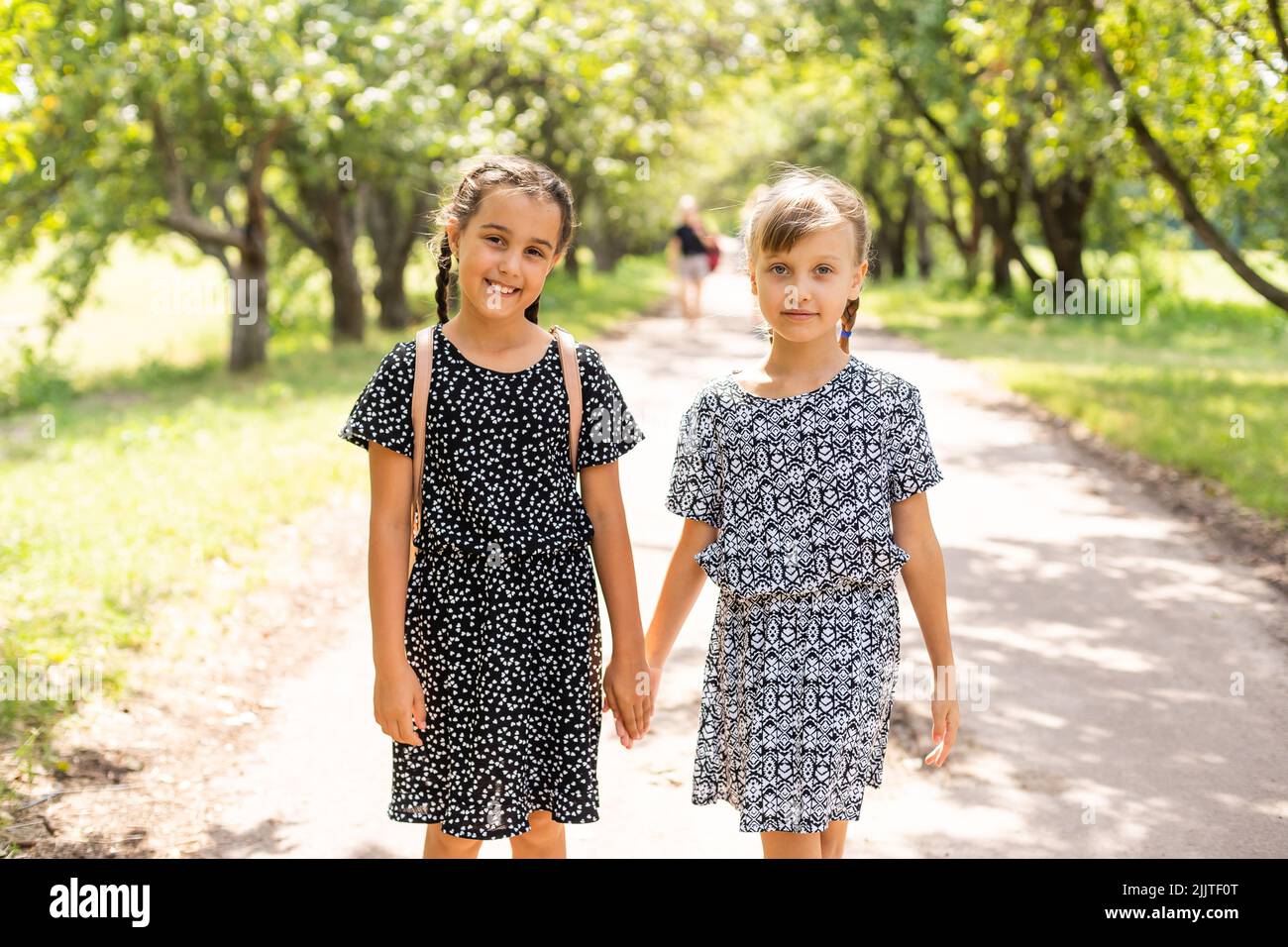 Basic school students crossing the road Stock Photo - Alamy