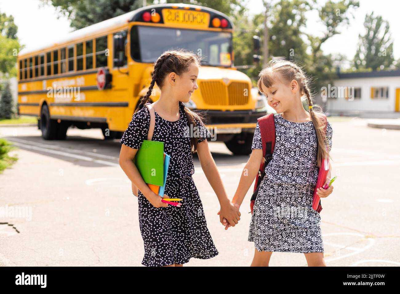 Education: Smiling Student Friends Ready For School next to school bus ...