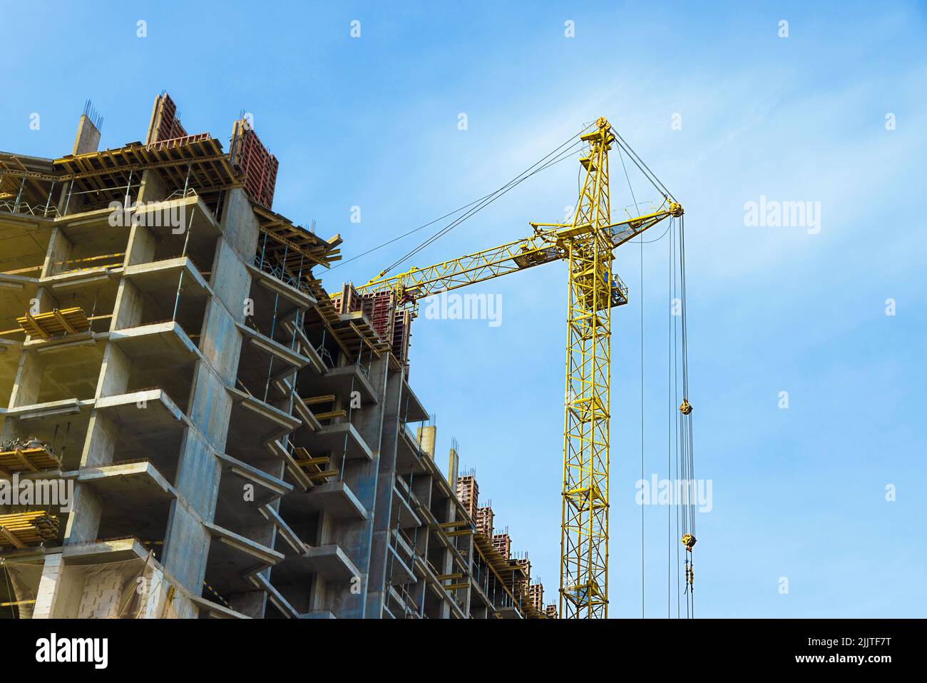 the yellow crane delivers construction materials when a new house is ...