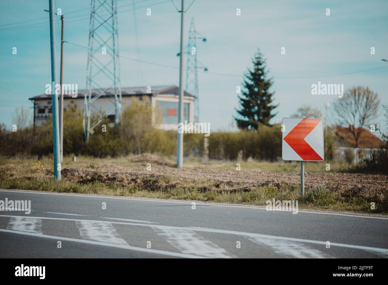 The red arrow warning sign on the left turn on the roadside Stock Photo ...
