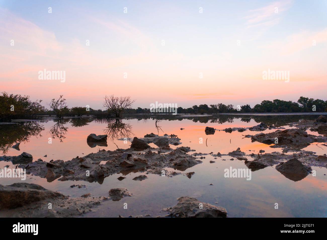 A mesmerizing view of sunrise reflecting in the water Stock Photo - Alamy