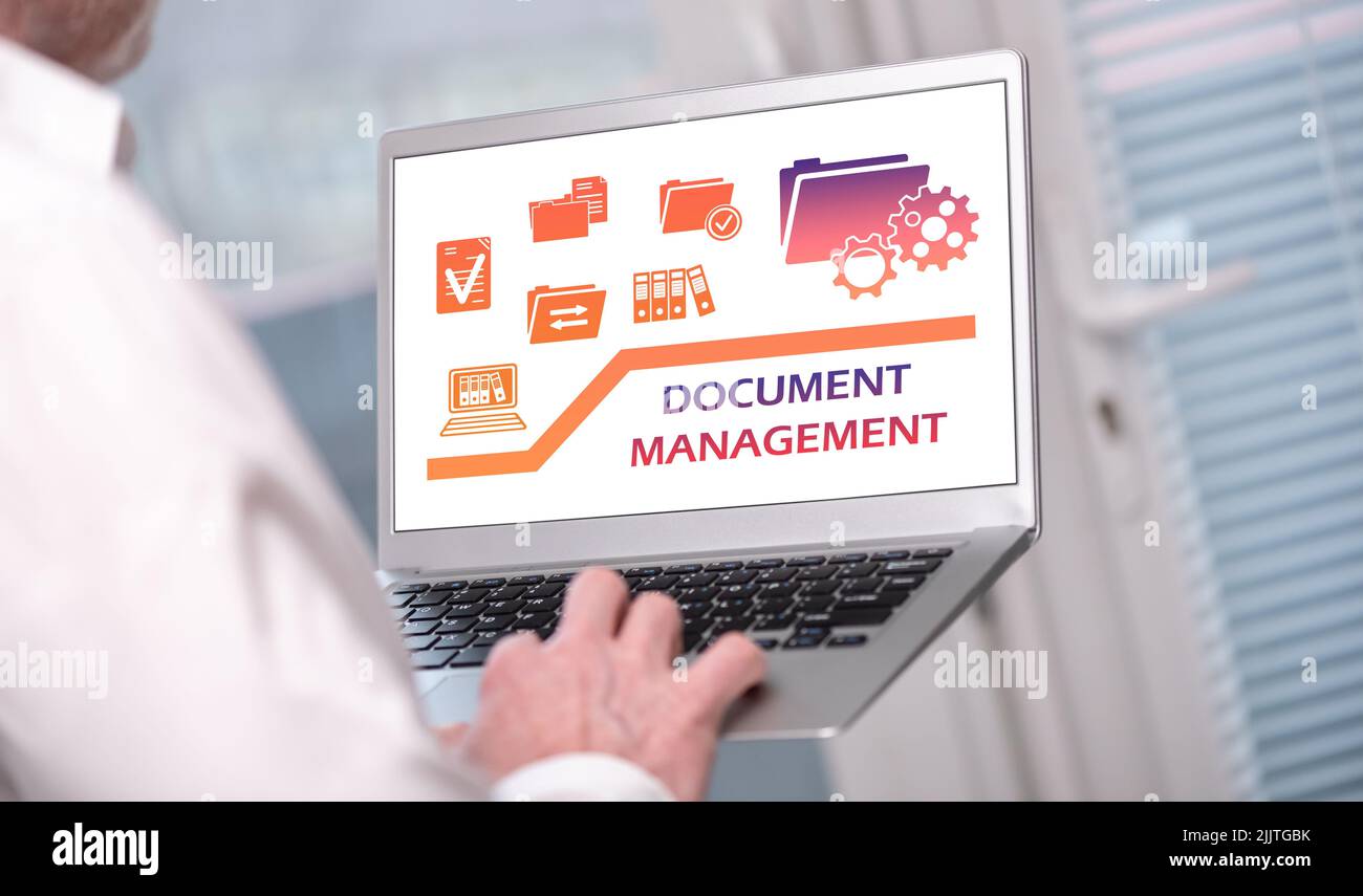 Document management concept shown on a laptop used by a man Stock Photo ...