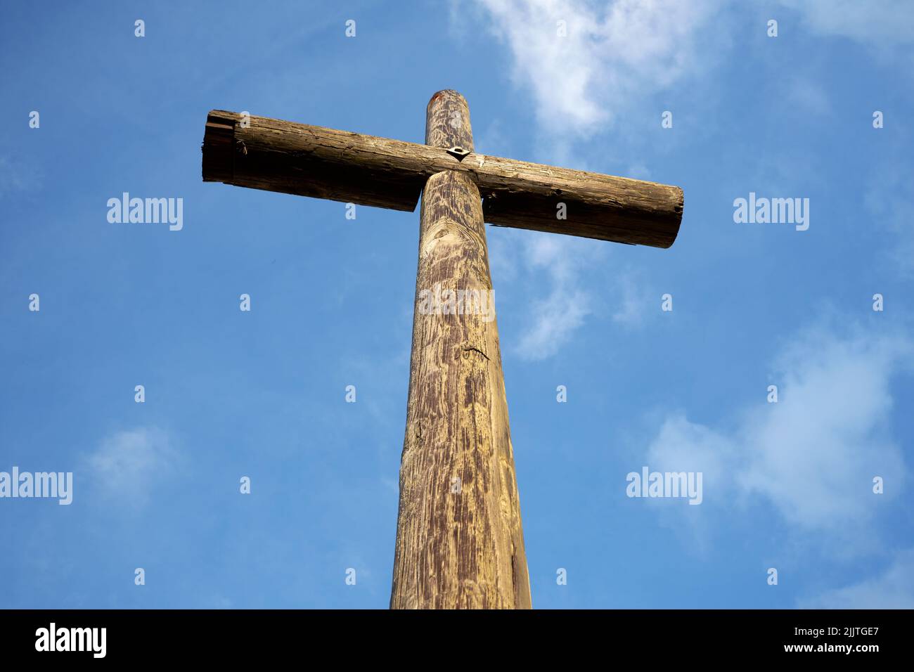 A low angle of a wooden cross against blue sky background Stock Photo ...