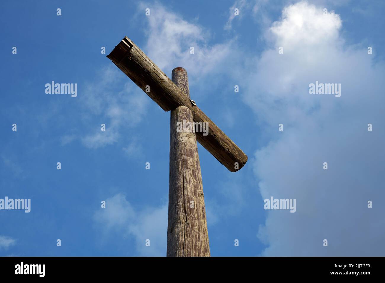 A low angle of a wooden cross against blue sky background Stock Photo ...