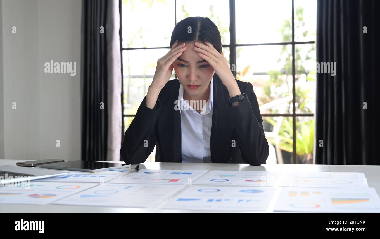 Stressed working woman reading document, solving business problem ...