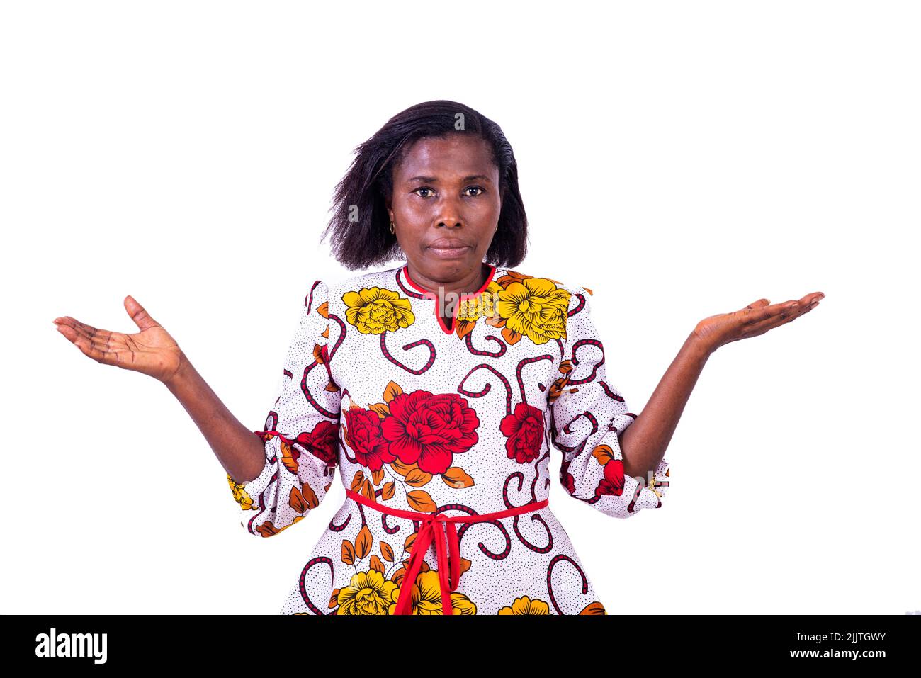 adult woman standing showing both hands palms open while looking at the ...