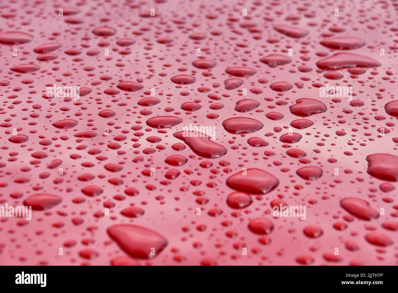 A full-frame shot of rain drops on a red glossy surface Stock Photo - Alamy