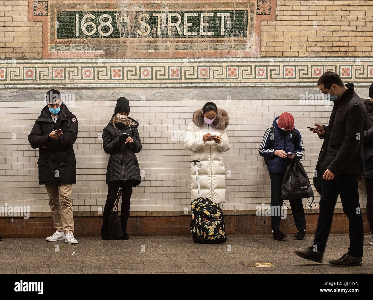 The 168th st subway with people using their mobile phones Stock Photo ...