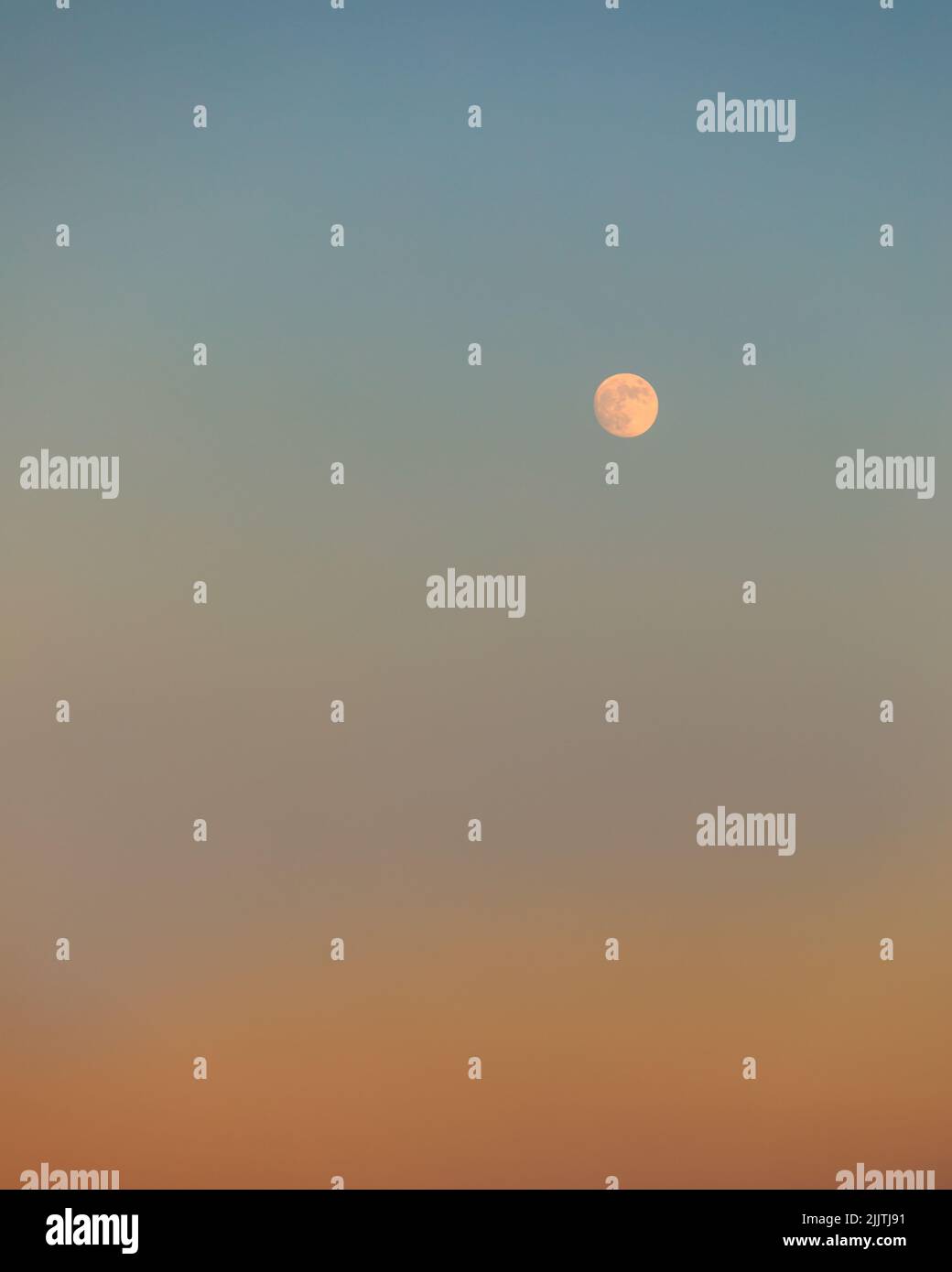 A moon appearing in sky during sunset Stock Photo - Alamy