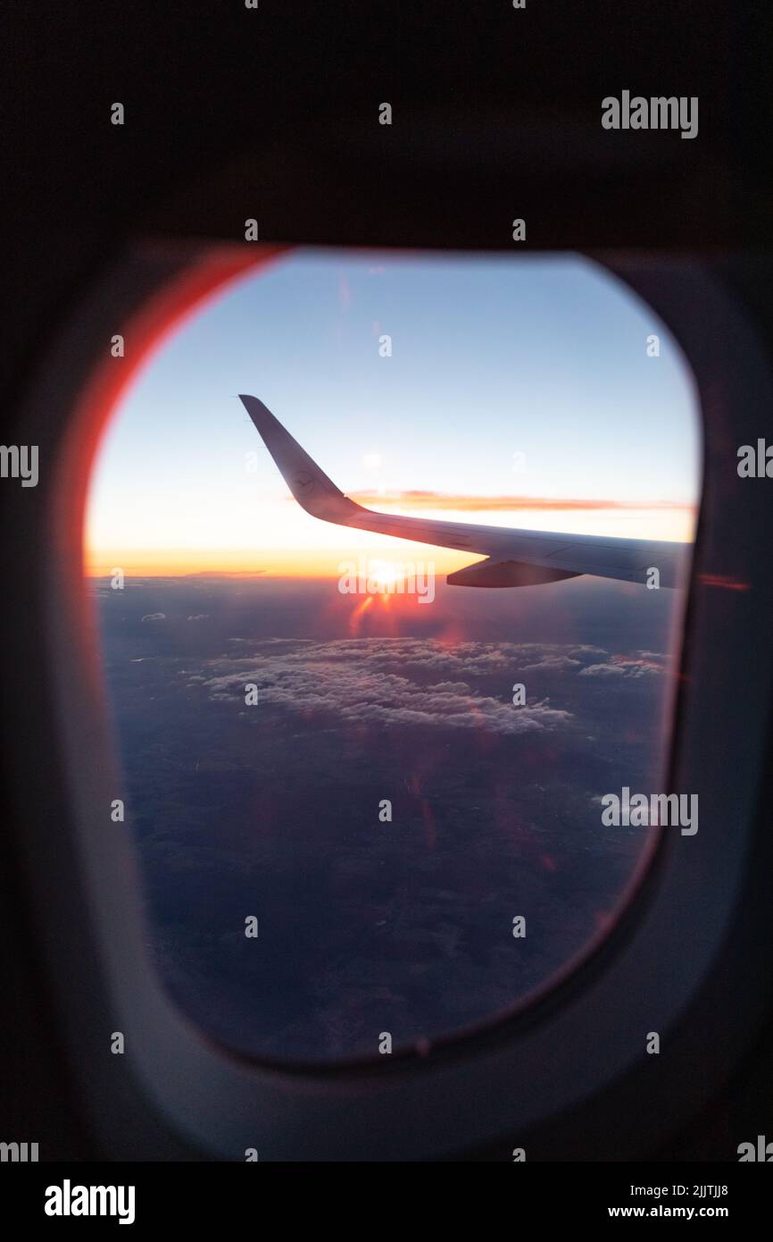 A beautiful shot from an airplane's window of its wing during sunset ...