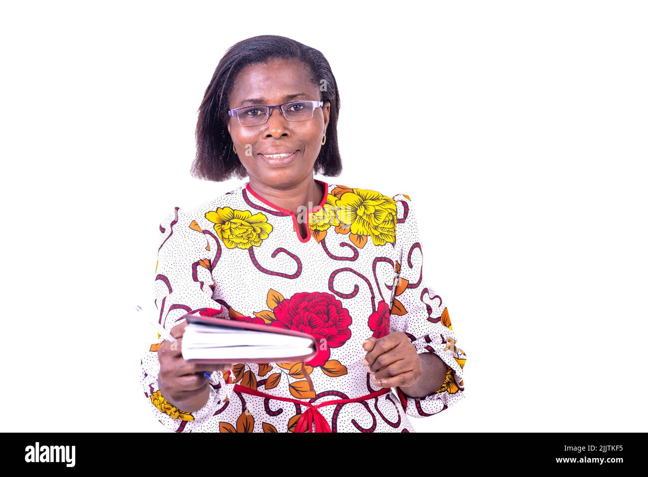 adult businesswoman wearing glasses, giving notebook while smiling at ...
