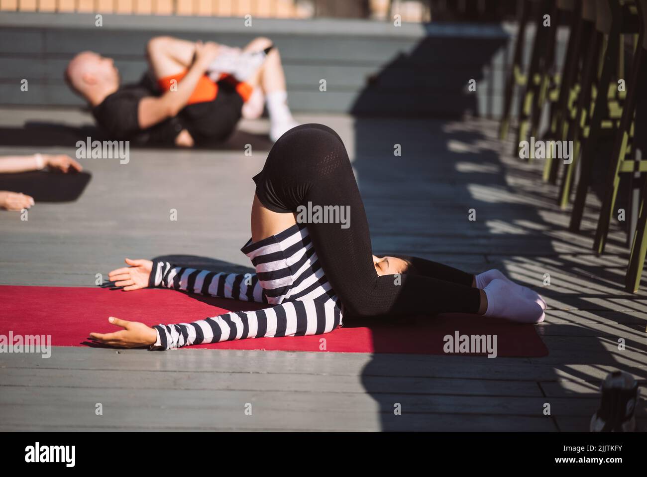 Yogi woman and diverse group of sporty people practicing yoga Stock ...