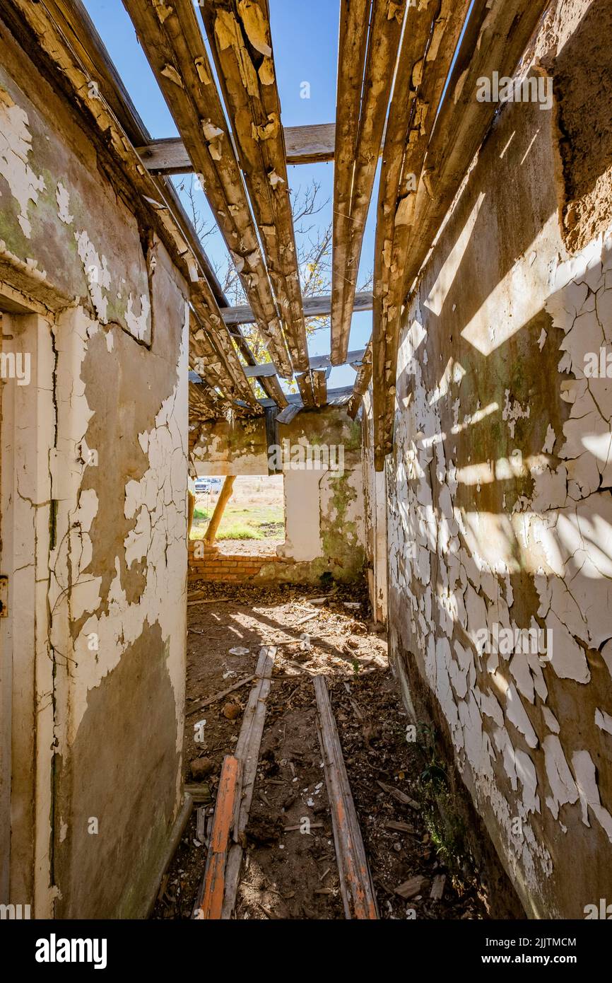 An inside view of an old abandoned weathered building with cracked ...