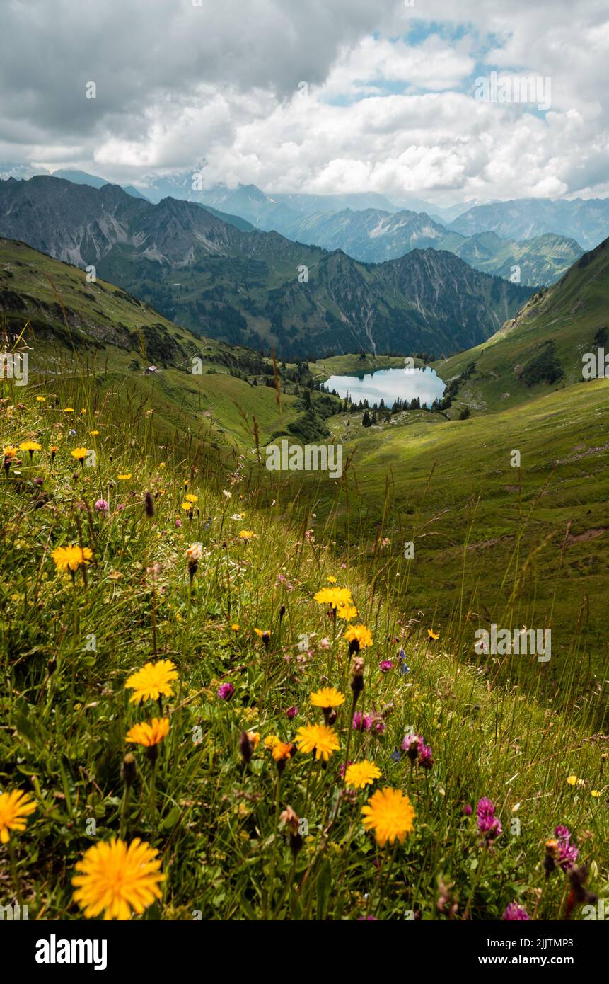 A vertical distant view of the lake Seealpsee between Alps mountains in ...