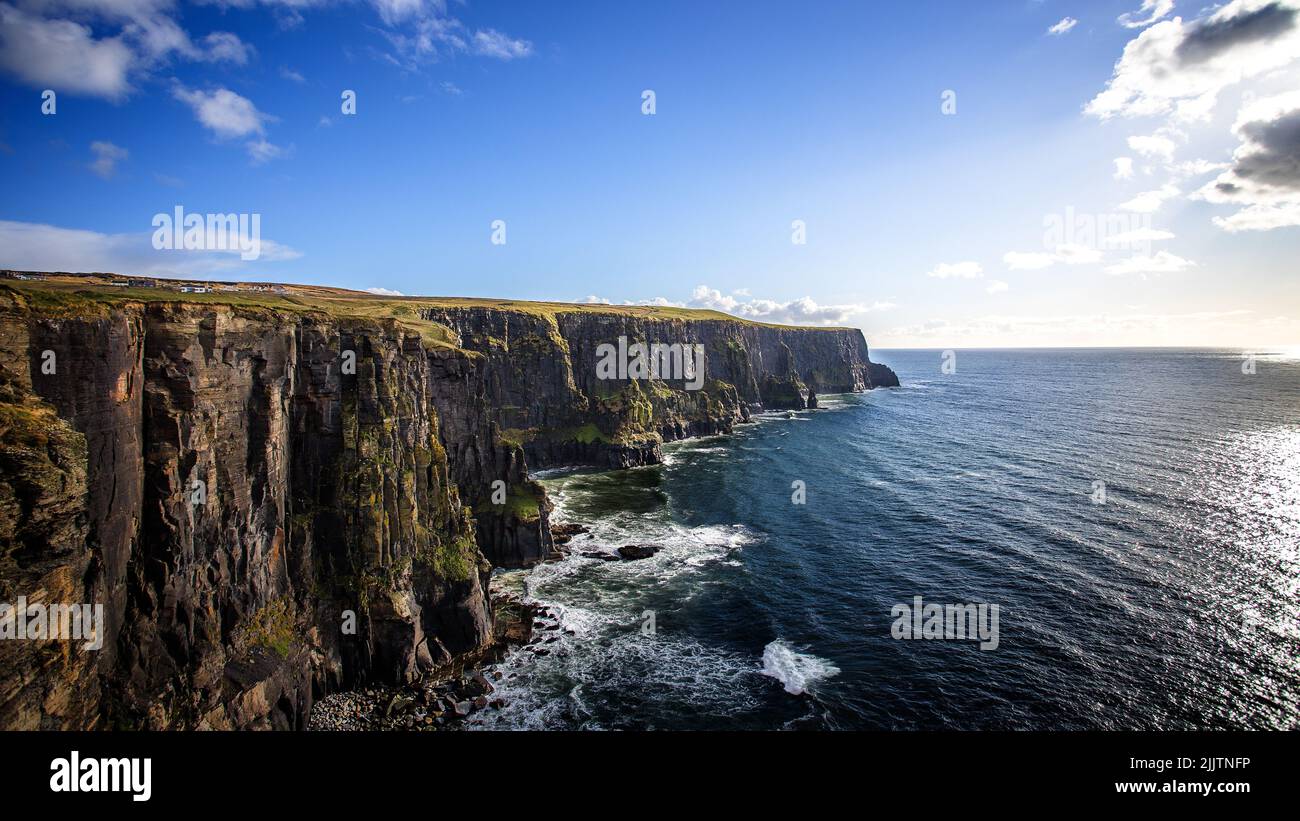 A beautiful landscape of a green cliff near the ocean on the sunrise ...